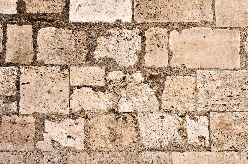 Brick Wall with a Cement Overlay, Featuring a Textured Pattern of Small ...