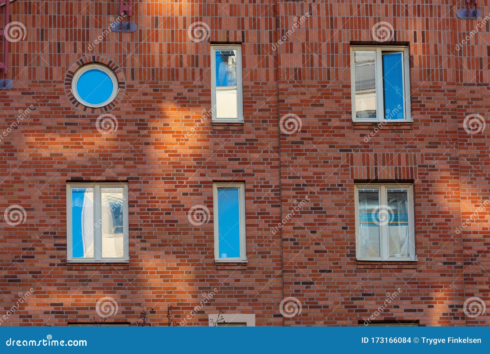 Brick Wall with Five Square Windows and One Round Stock Photo - Image ...