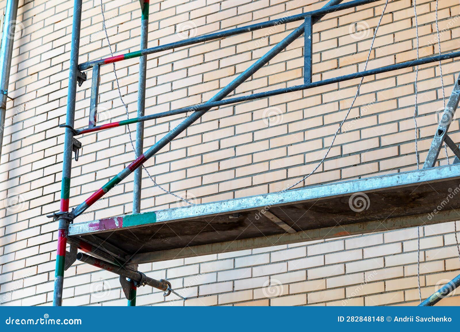 Brick Wall and Scaffolding. Scaffolding Near the Building Stock Photo ...