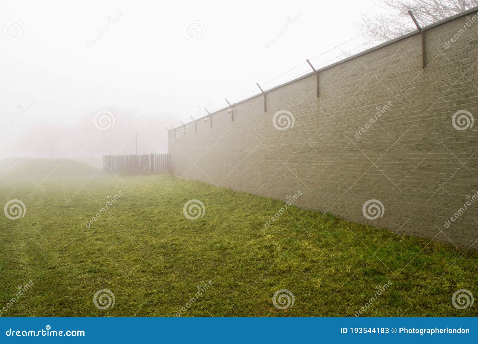 Photo of Brick Wall Surrounding Field Stock Image - Image of summer ...