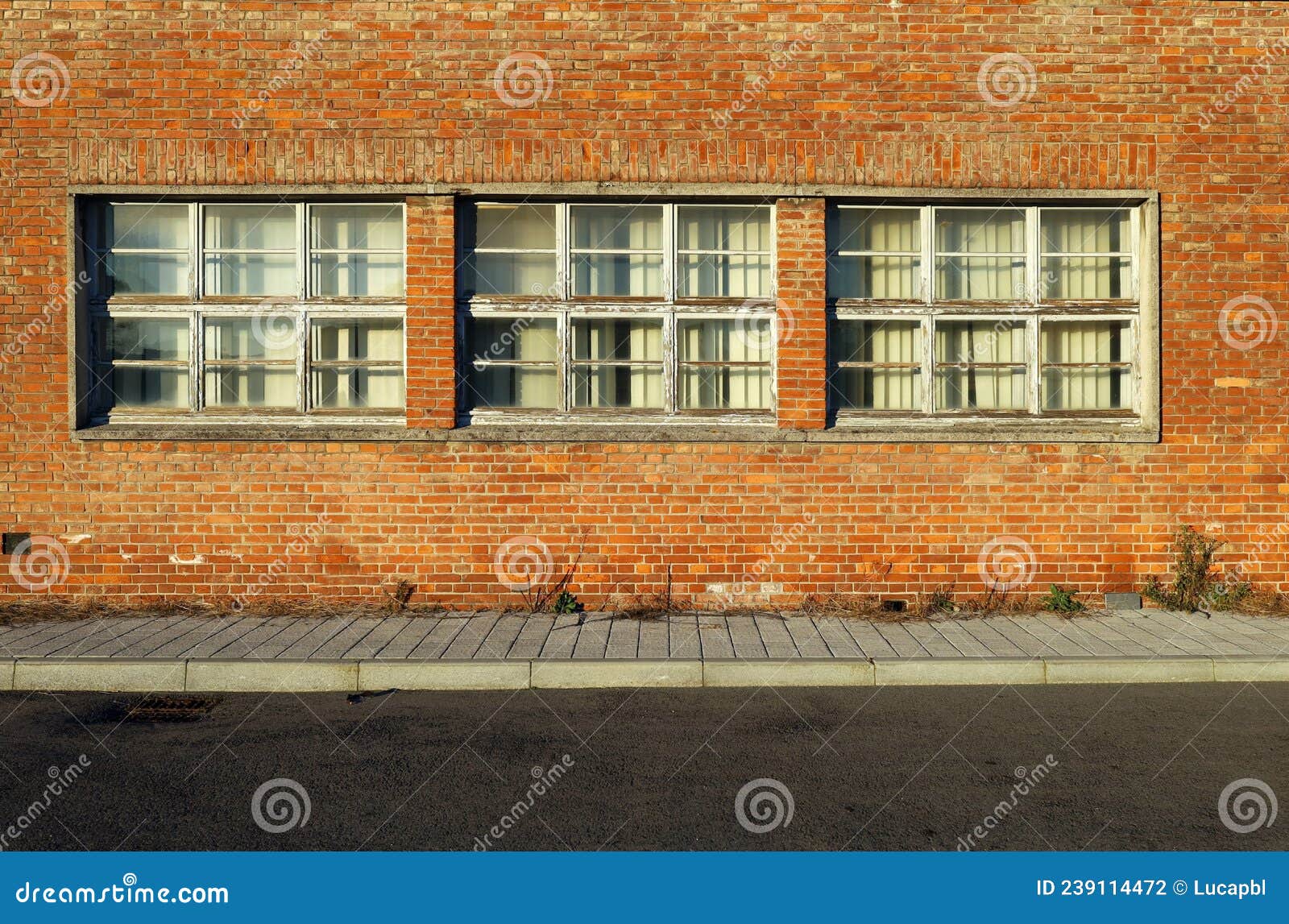 Brick Wall with Three Large Windows and Curtains. Tiled Concrete ...