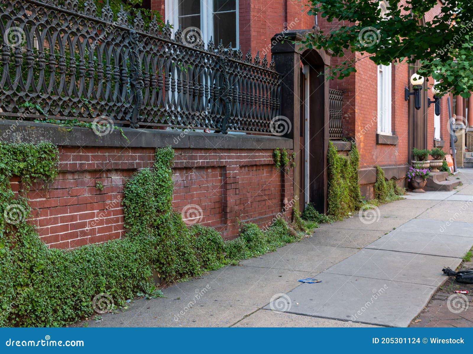 Brick Wall Topped with an Iron Railing in the City Stock Photo - Image ...