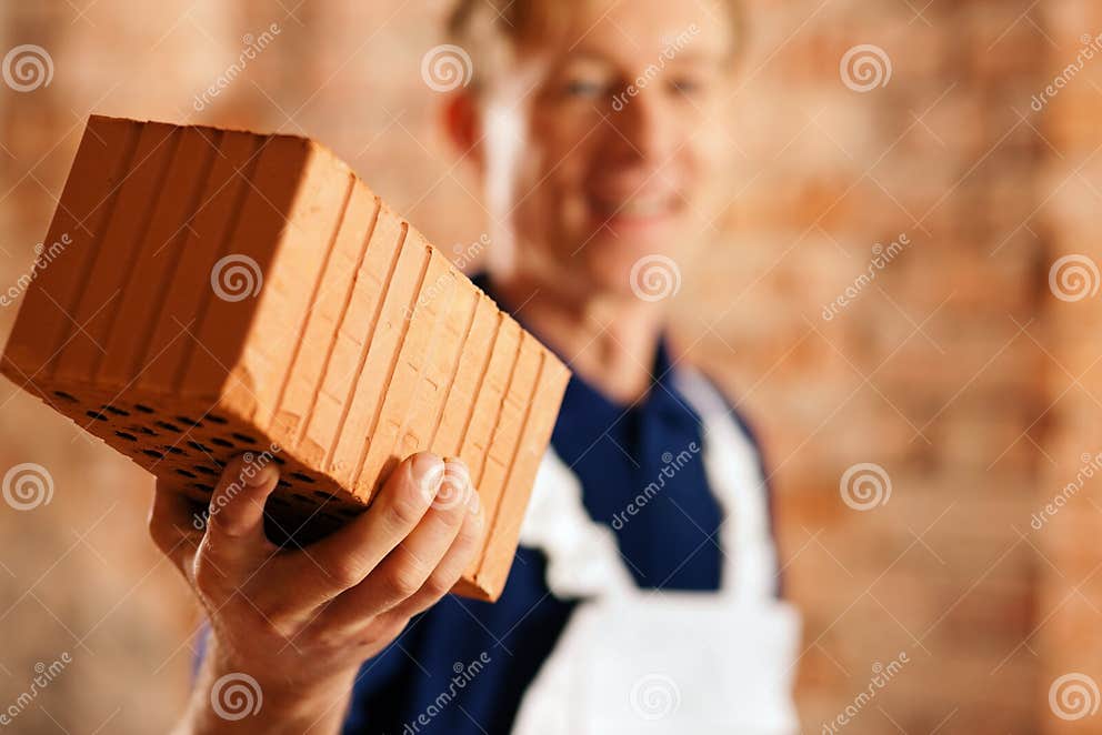 Bricklayer with Brick on Construction Site Stock Photo - Image of ...