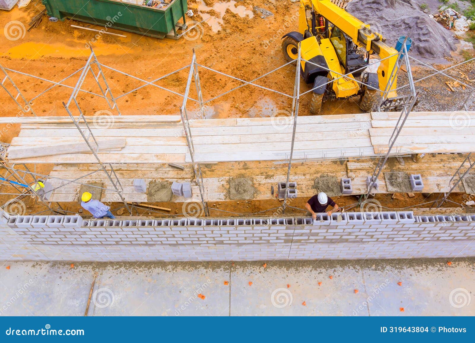 Bricklayer Builds Working Concrete Wall from Concrete Blocks while ...