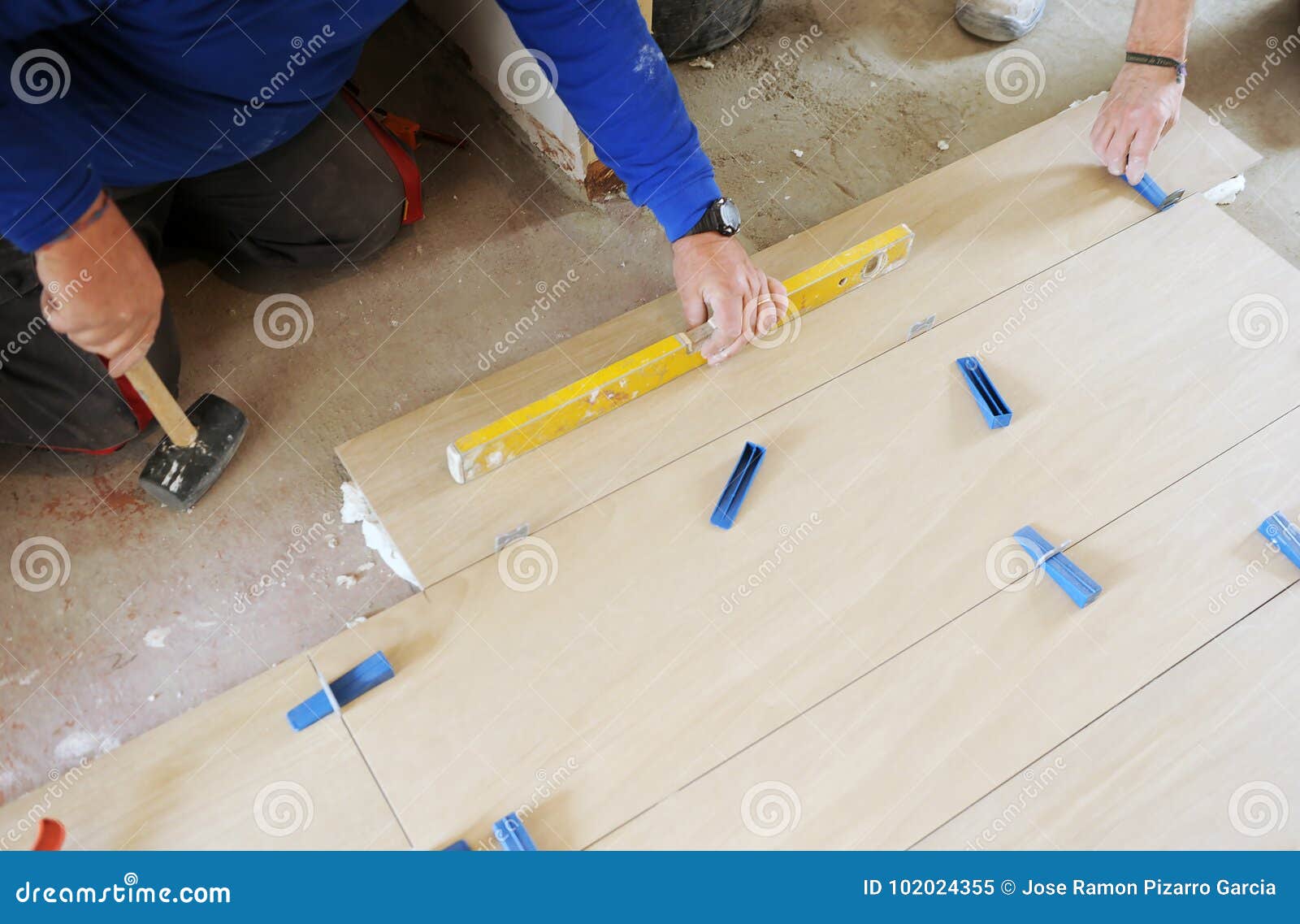 Bricklayer Checking the Leveling of a Porcelain Stoneware Floor with ...