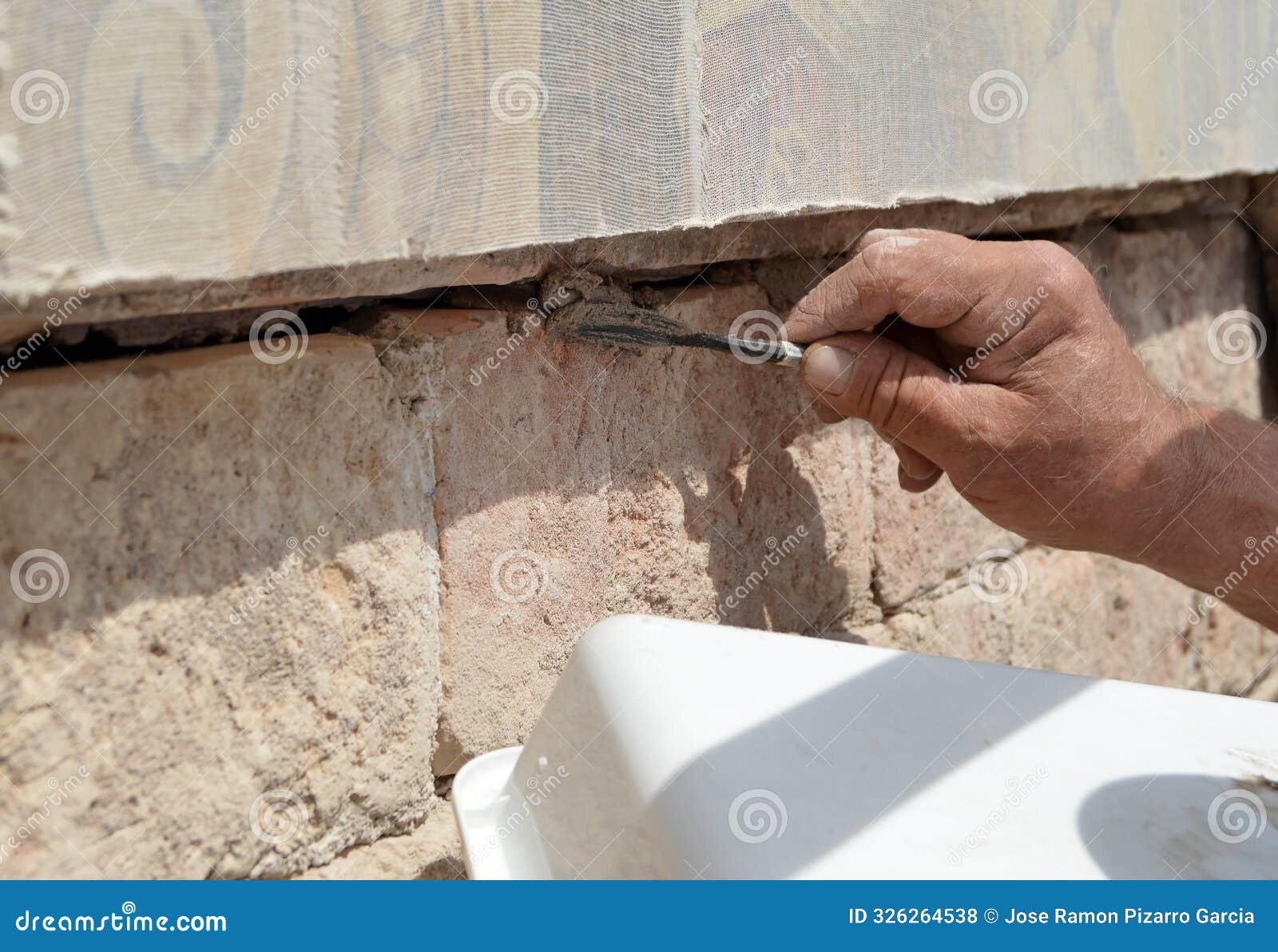 Bricklayer Consolidating an Old Block Brick Wall with Chemical Fixation ...