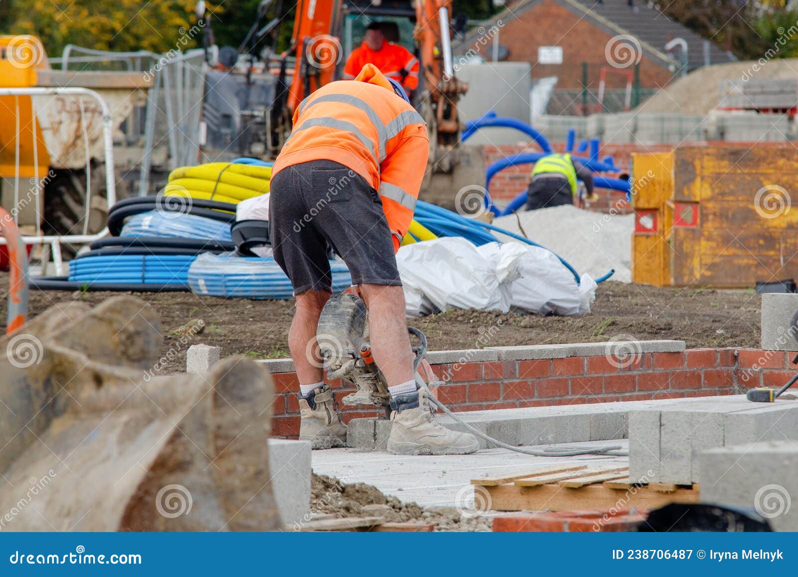 Bricklayer Cutting Concrete Blocks Using Petrol Disc Cutter while ...