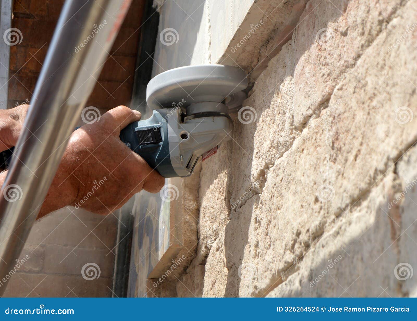 Bricklayer Cutting an Old Solid Brick Wall with Electric Radial Cutter ...