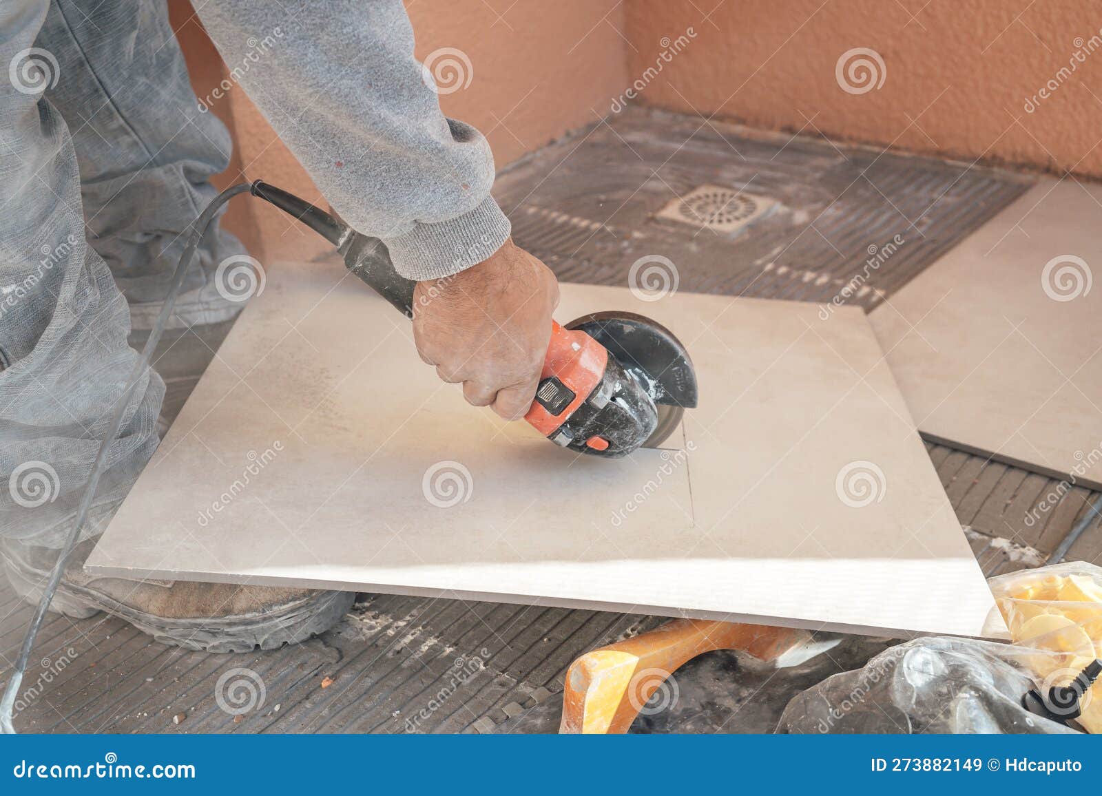 Bricklayer Cutting Some Tiles with a Grinder To Put on a Floor. Working ...