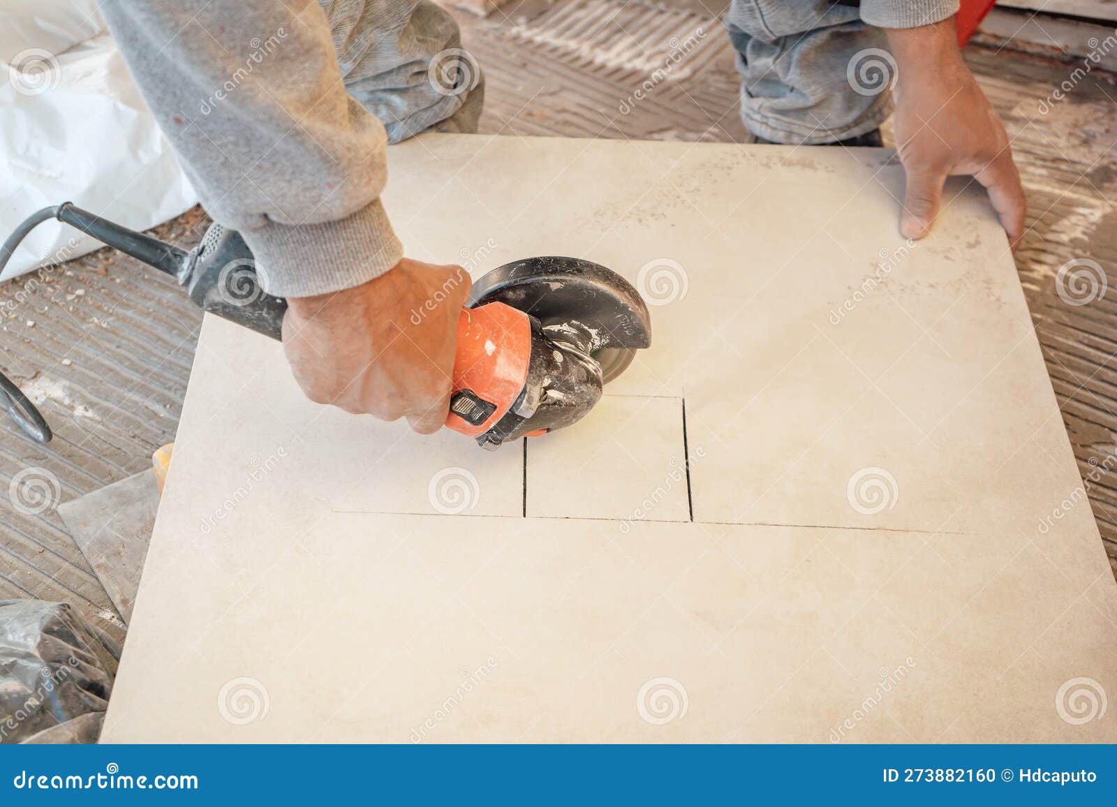 Bricklayer Cutting Some Tiles with a Grinder To Put on a Floor. Working ...