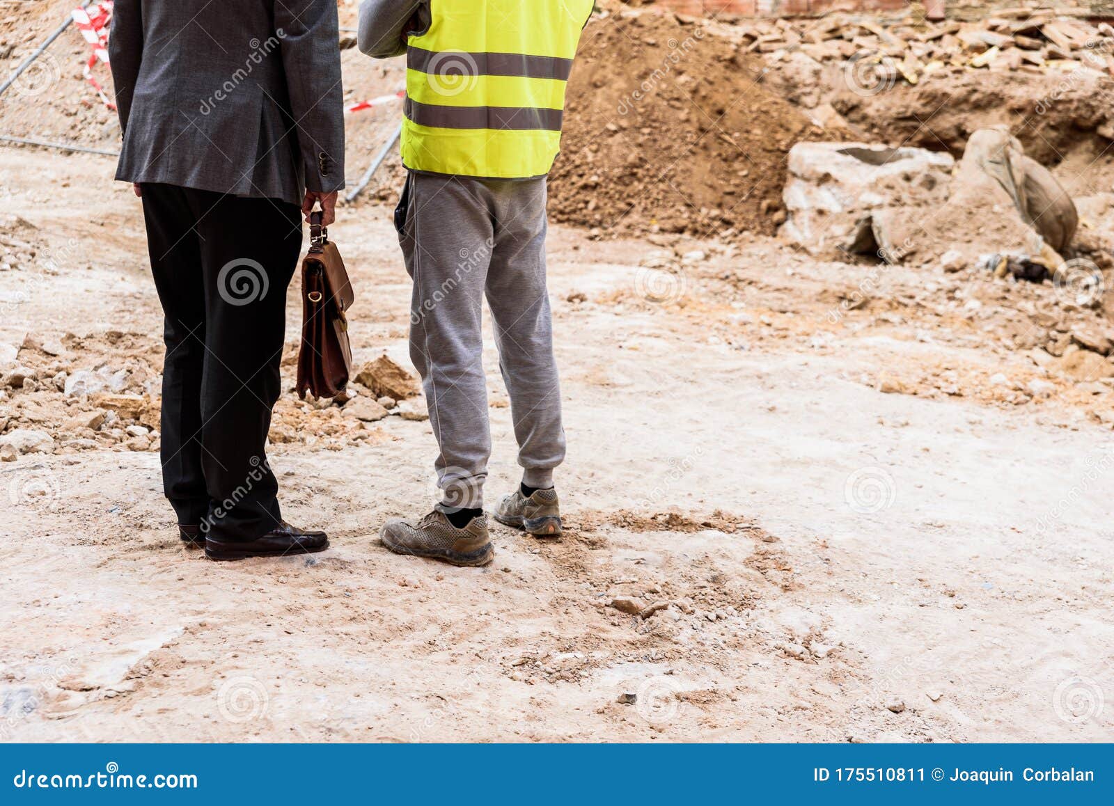 A Bricklayer with His Boss Supervise the Work of an Excavator on a ...