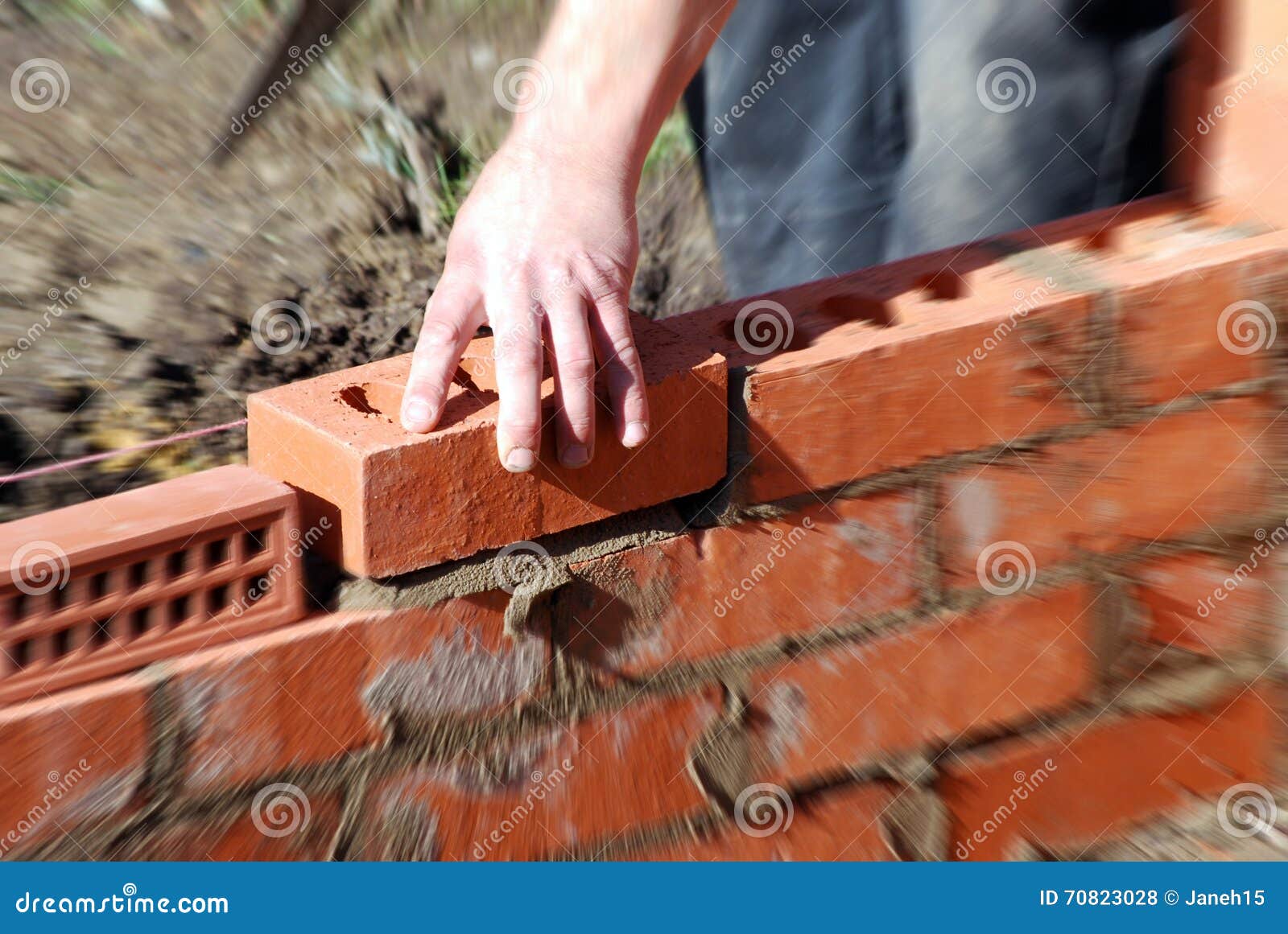 Bricklayer holding brick stock photo. Image of brick - 70823028