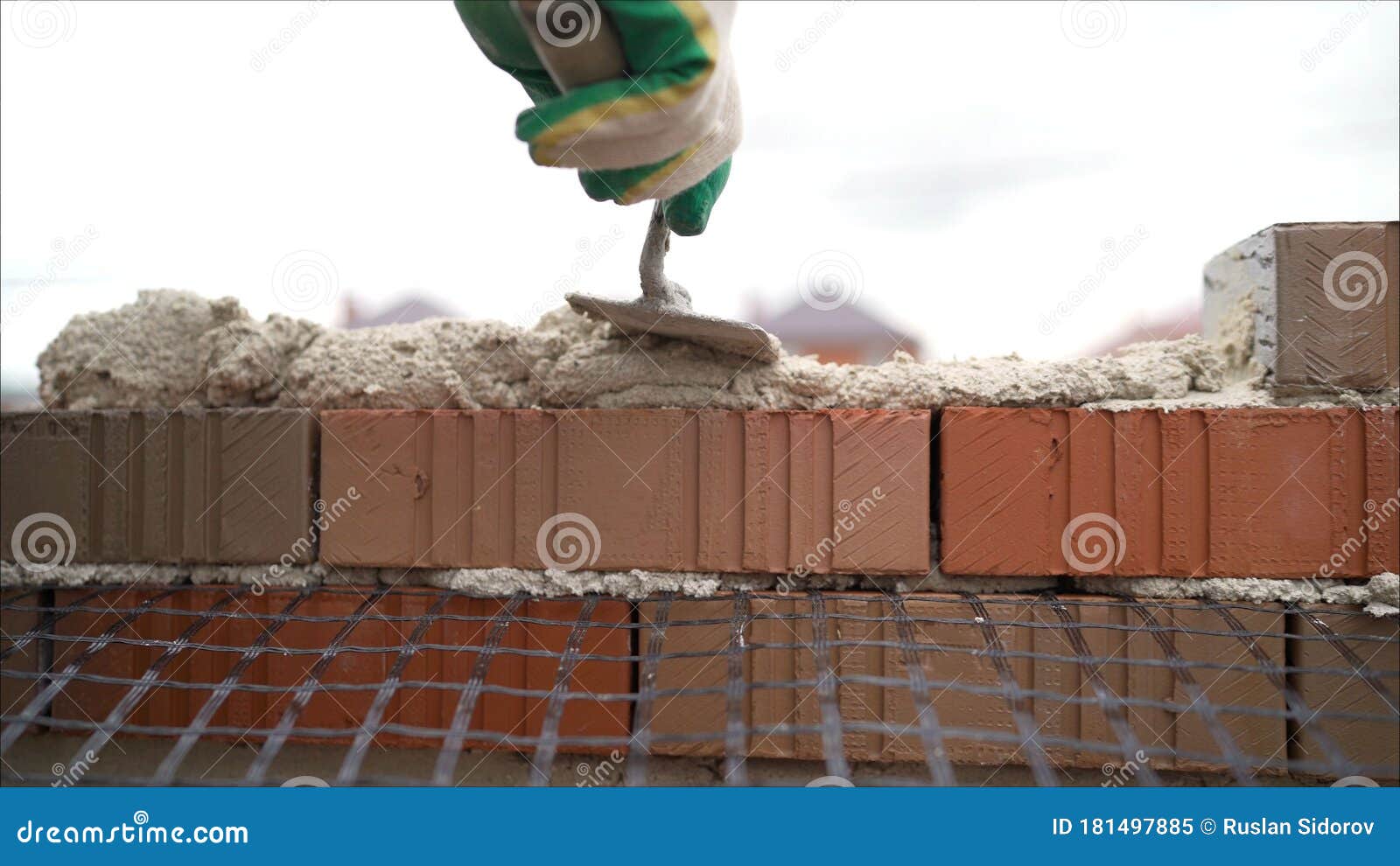 Bricklayer Laying, Well, Bricks To Make a Wall, he is Pulling Grout Out ...