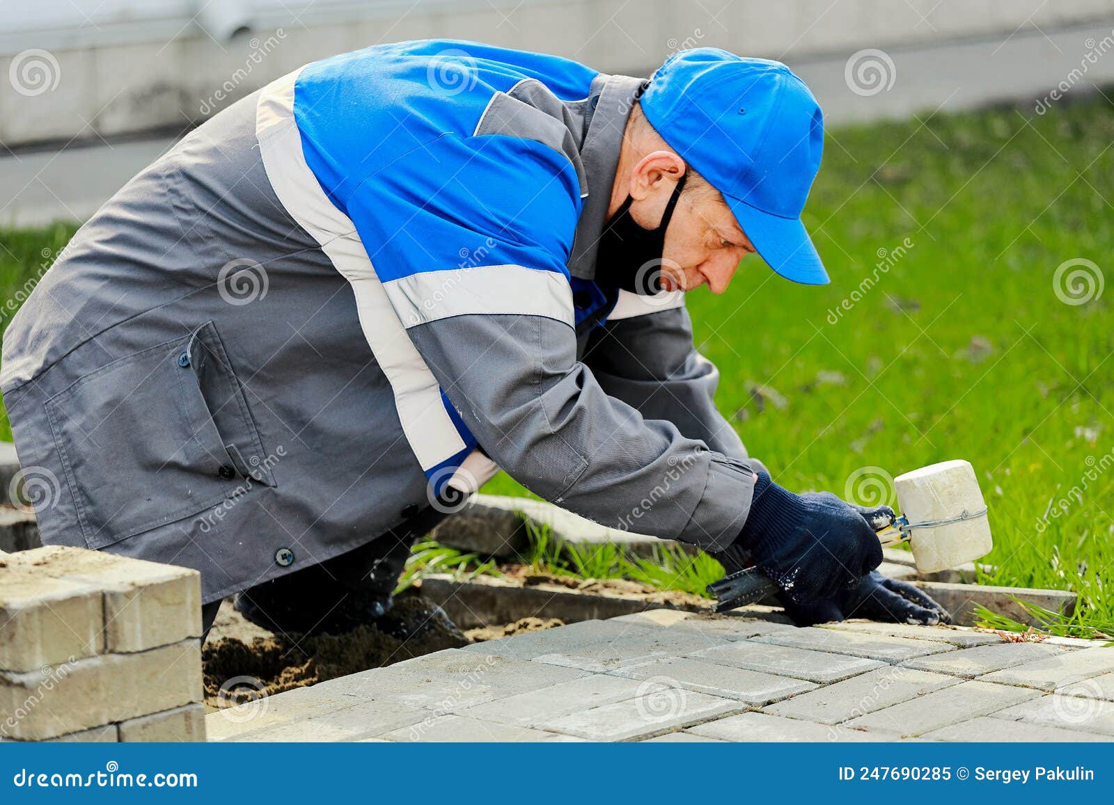 Bricklayer Lays Paving Slabs Outside. Working Man Performs Landscaping ...