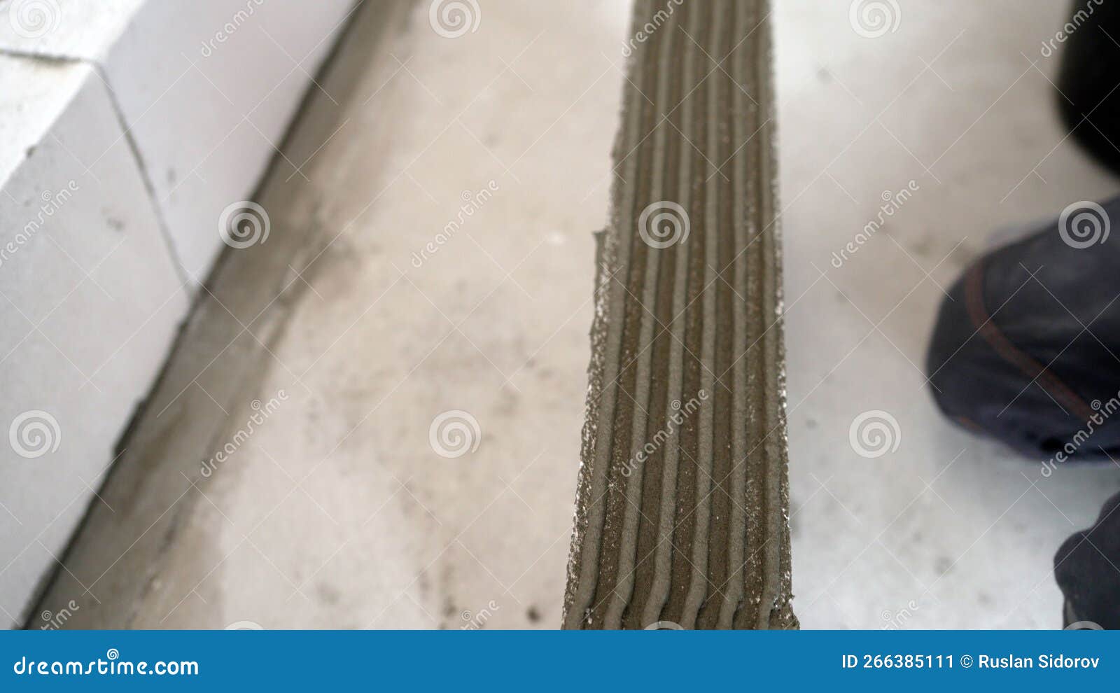 A Bricklayer Makes a Concrete Wall from a Cement Block and Plaster at a ...
