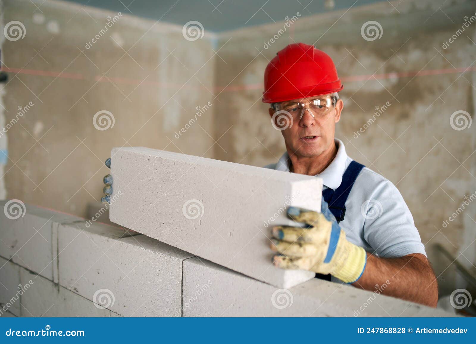 Bricklayer or Mason Lays Bricks To Construct Wall of Autoclaved Aerated ...