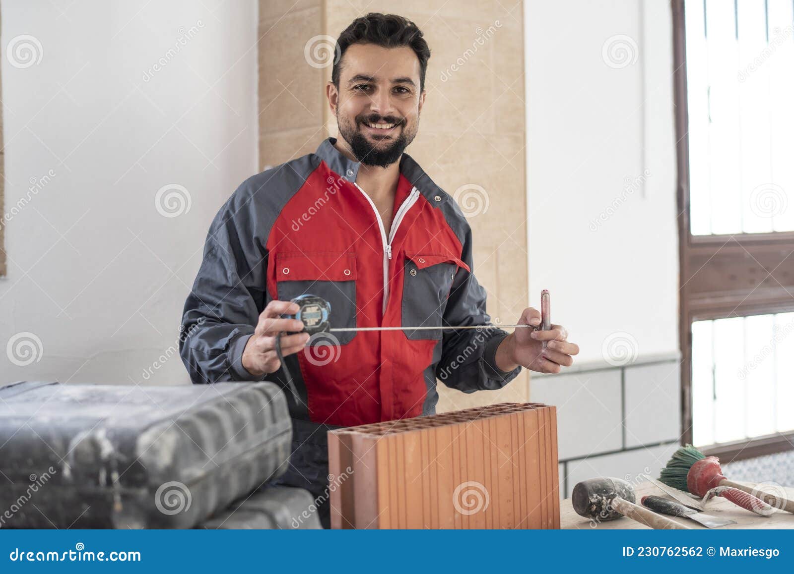Bricklayer with Measuring Tape Smiles Stock Photo - Image of industrial ...