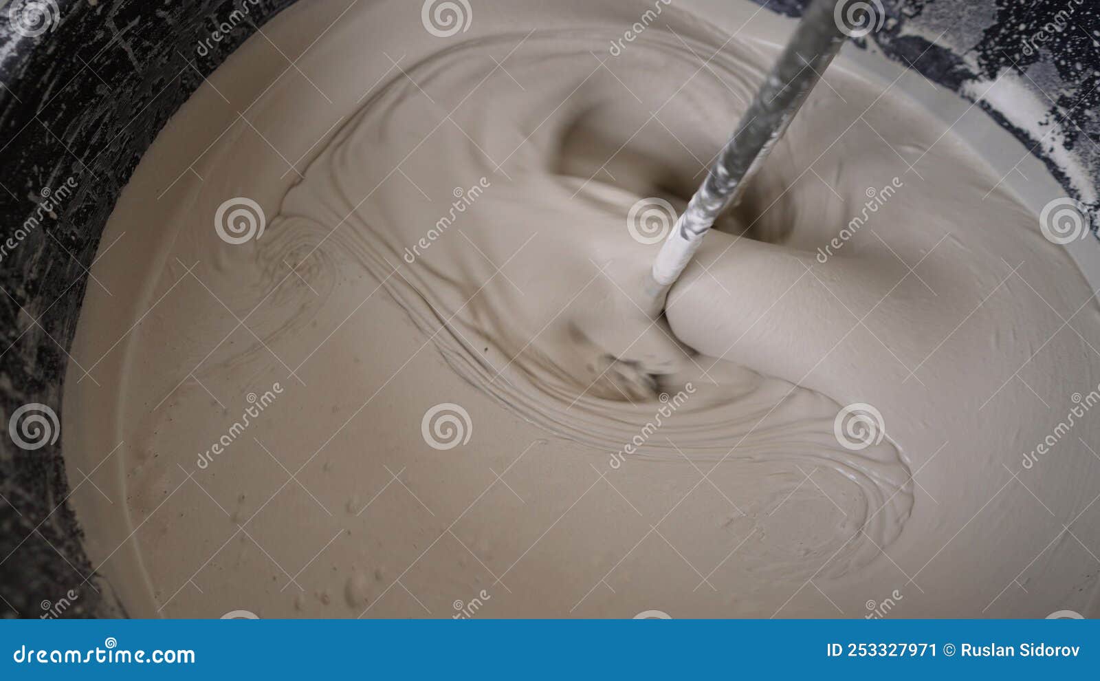 Bricklayer Mixes Cement in a Bucket. a Worker Using a Mixer Mixes the ...