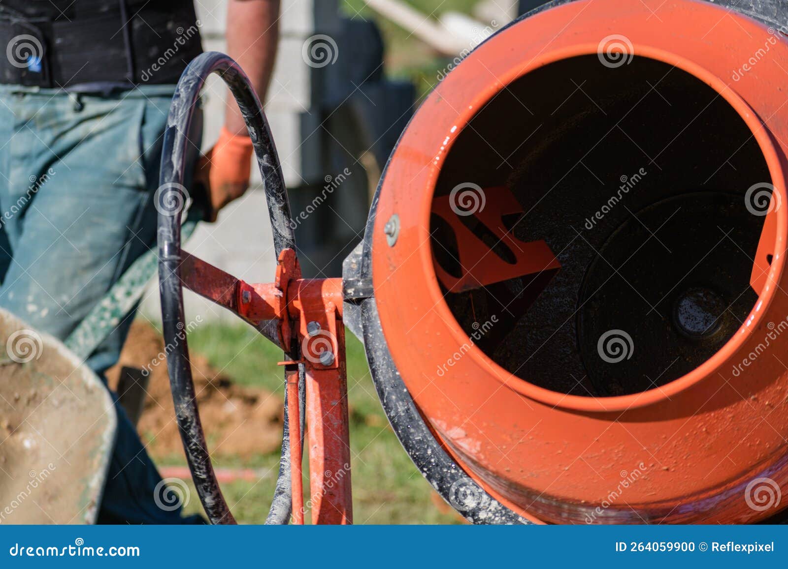 Bricklayer Preparing Concrete with a Cement Mixer To Build a Wall at a ...