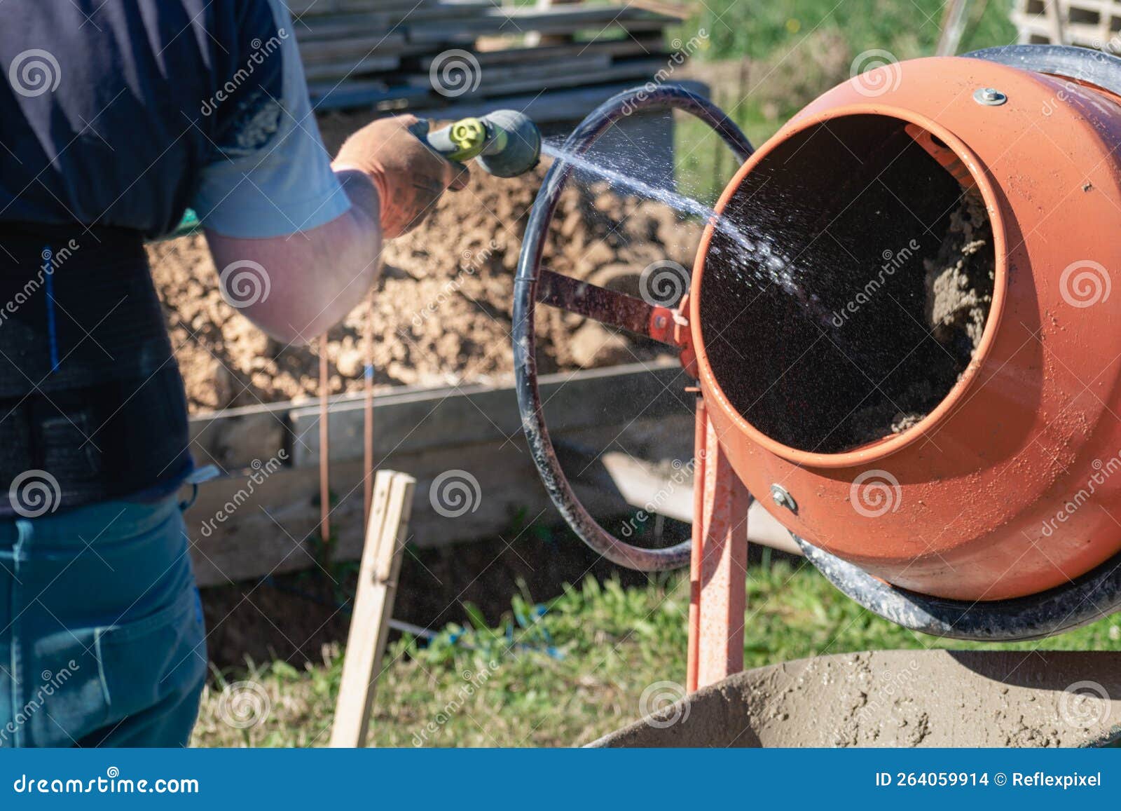 Bricklayer Preparing Concrete with a Cement Mixer To Build a Wall at a ...