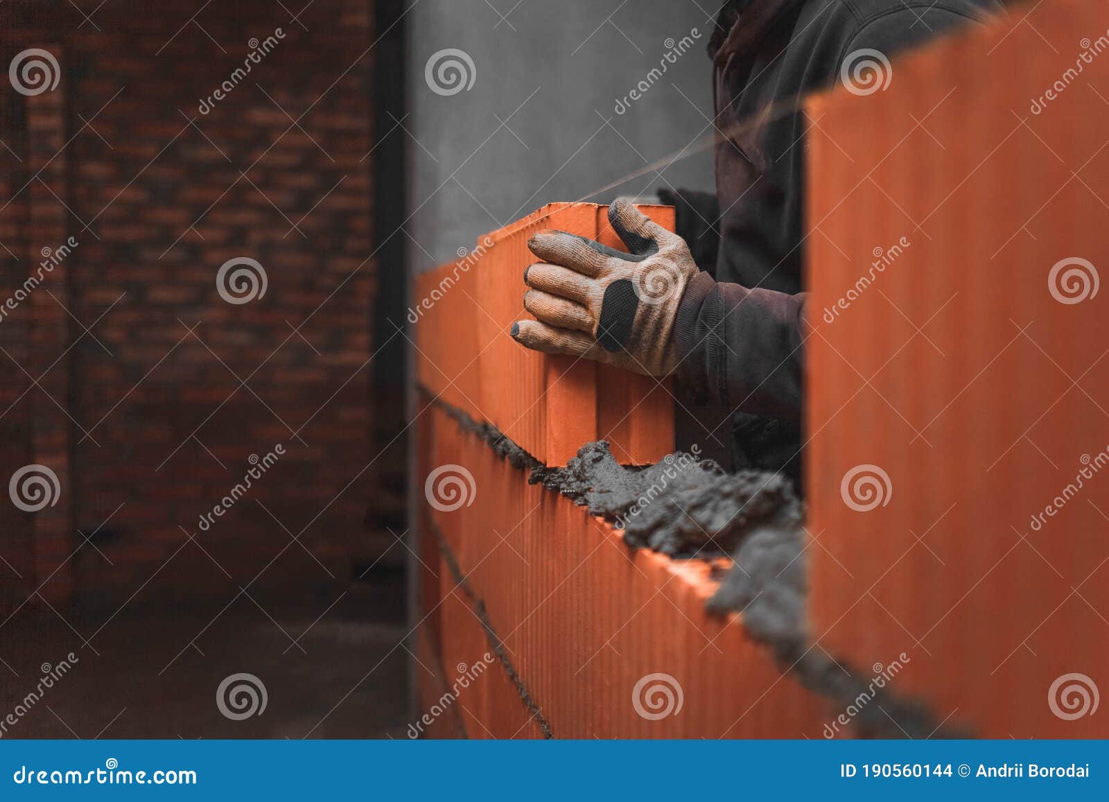 Builder Laying a Large Brick Block on the Mortar Creating a Wall Stock ...