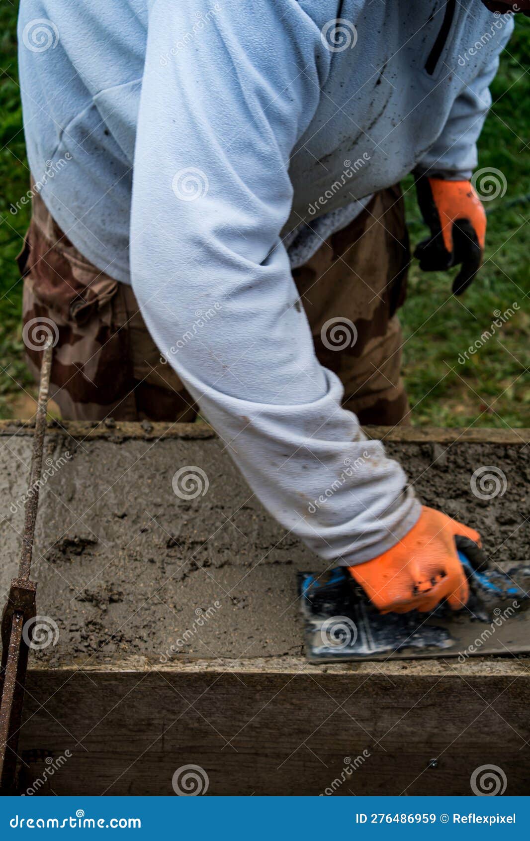 Bricklayer Spreading Concrete with a Trowel and Level To Build a Wall ...