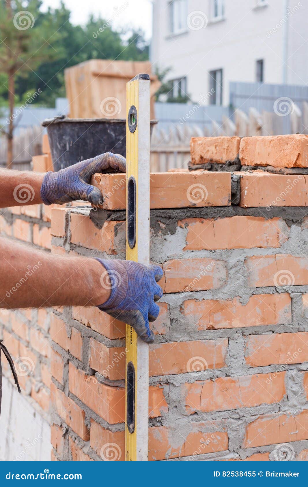 Bricklayer Using a Building Levell To Check New Red Brick Wall Outdoor ...