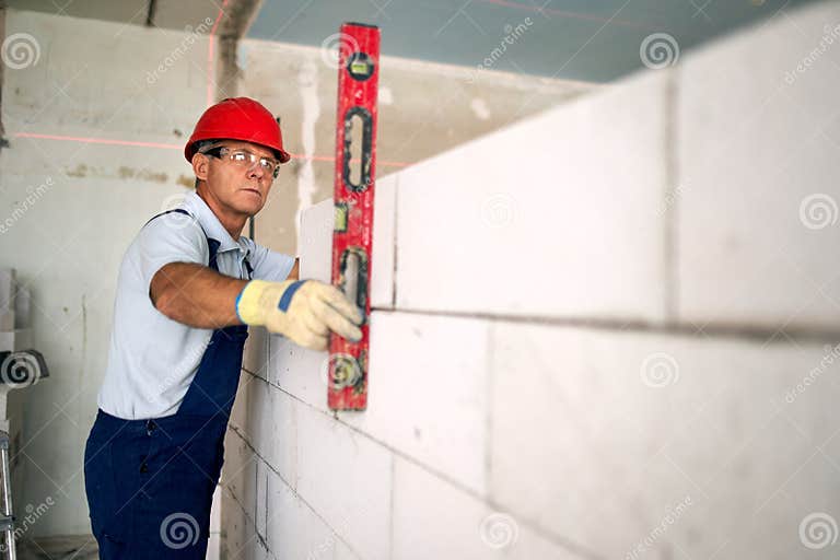 Bricklayer Using Spirit Bubble and Laser Level To Precise Check ...