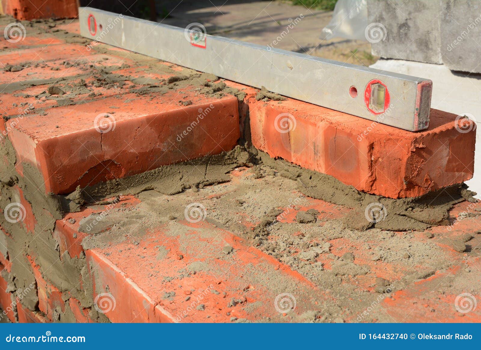 Bricklayer Using a Spirit Level To Check Bricklaying Wall Outdoors ...