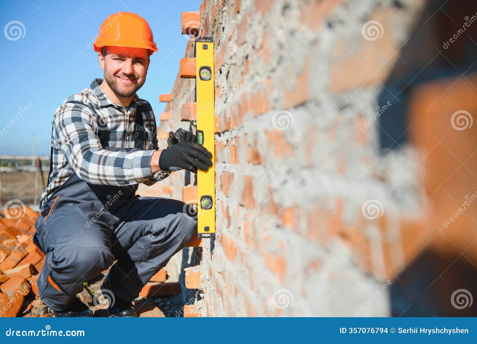 Bricklayer Using a Spirit Level To Check New Red Brick Wall Outdoor ...