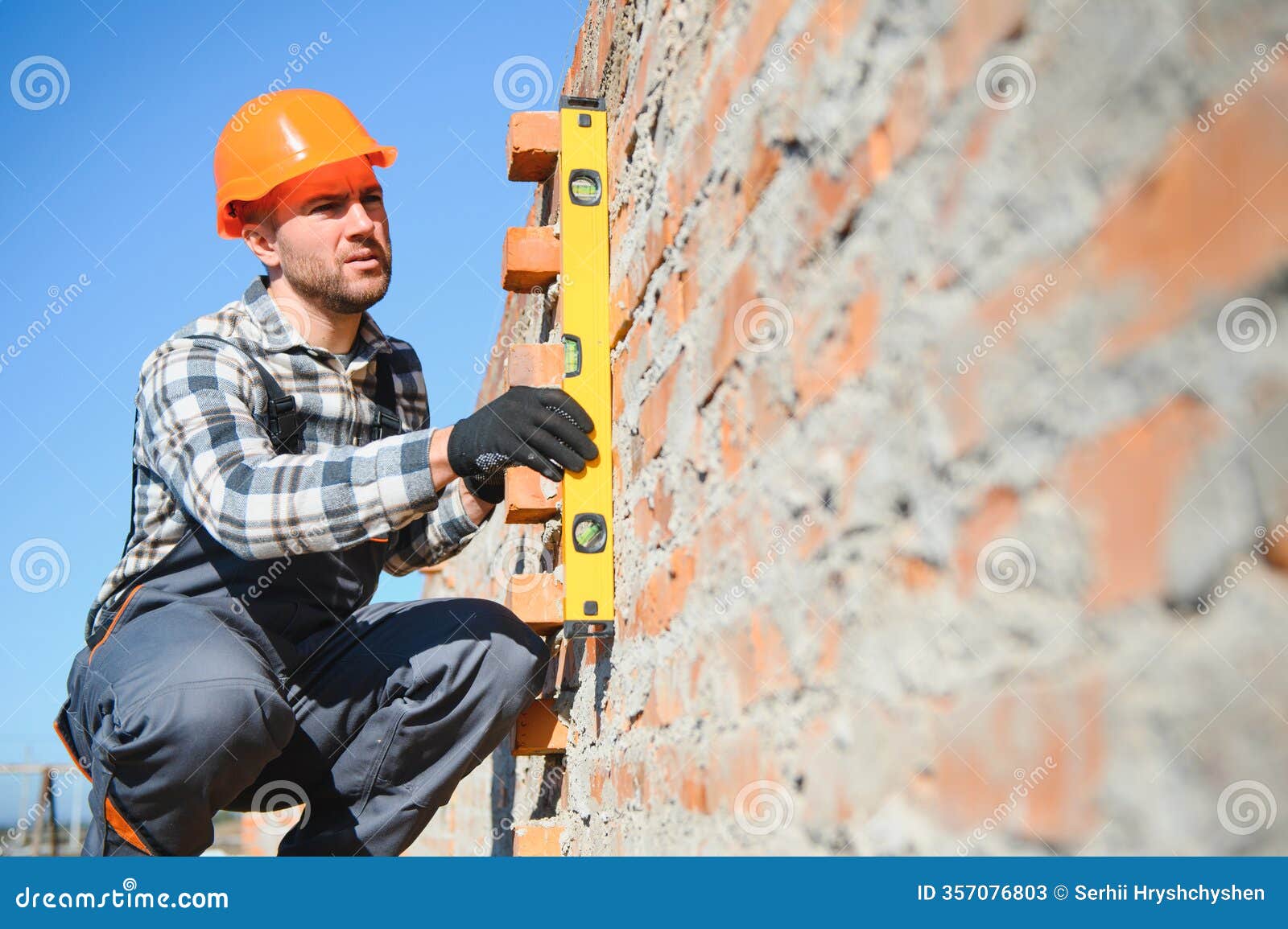 Bricklayer Using a Spirit Level To Check New Red Brick Wall Outdoor ...