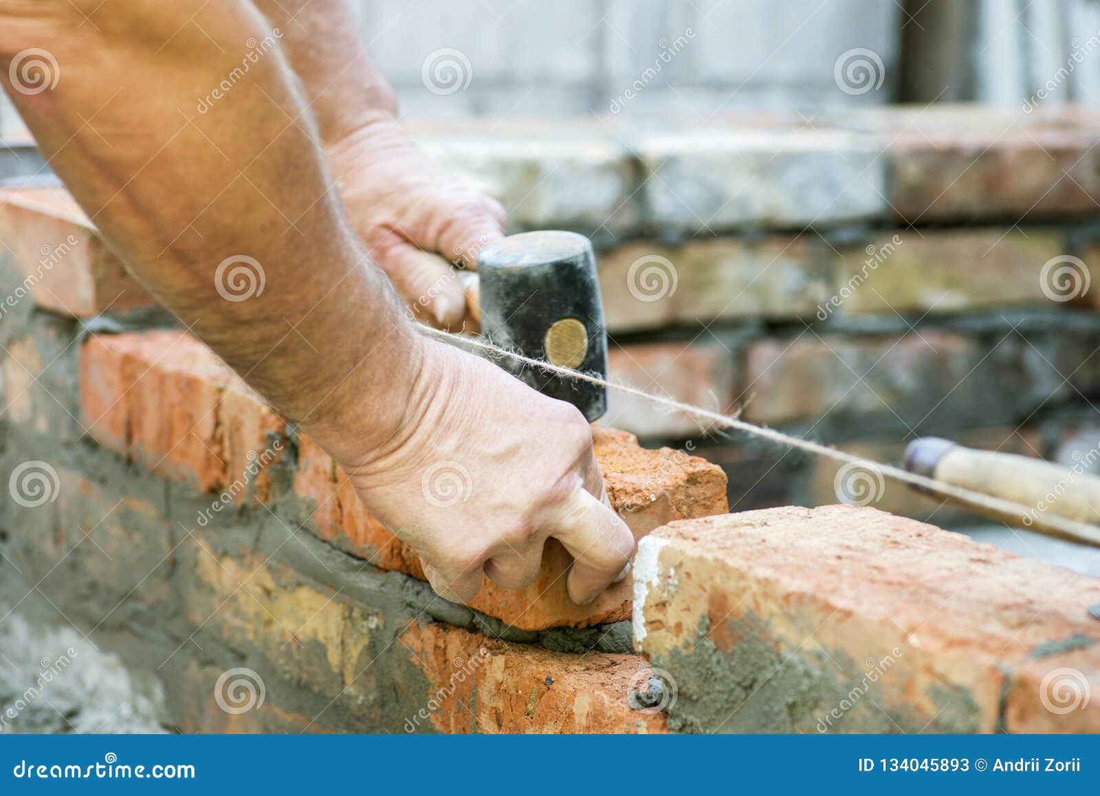 Bricklayer Worker Installing Brick Masonry on Exterior Wall ...