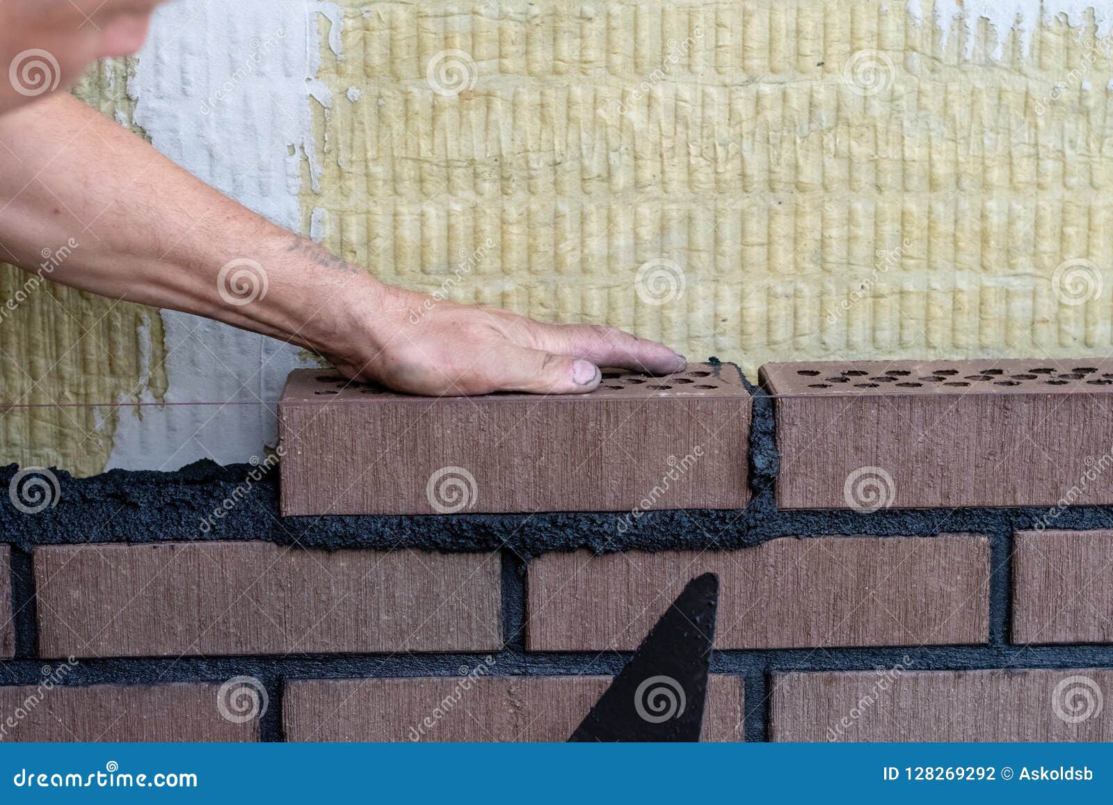 Bricklayer Worker Installing Bricks on Construction Site. Stock Photo ...