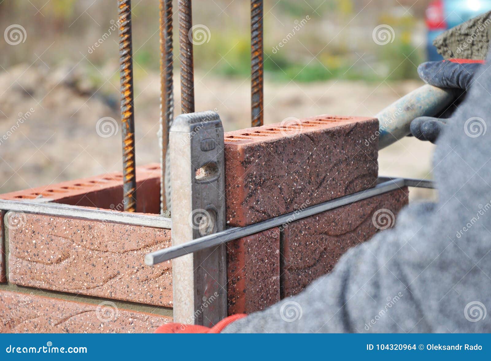 Bricklayer Worker Installing Brick Masonry On Exterior Wall With Hands ...
