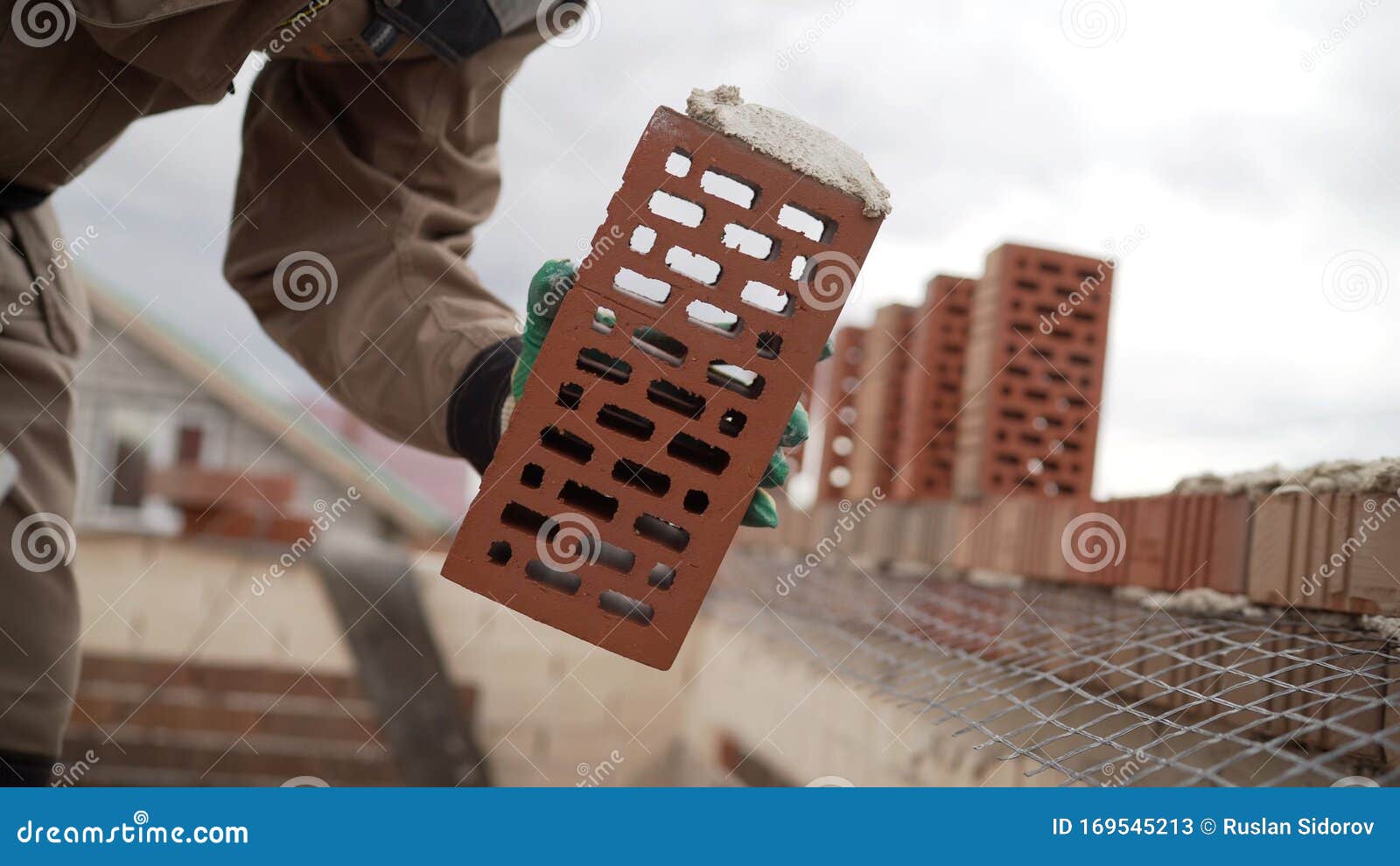 Worker Puts a Brick Wall. Bricklayer Working in Construction Site of a ...