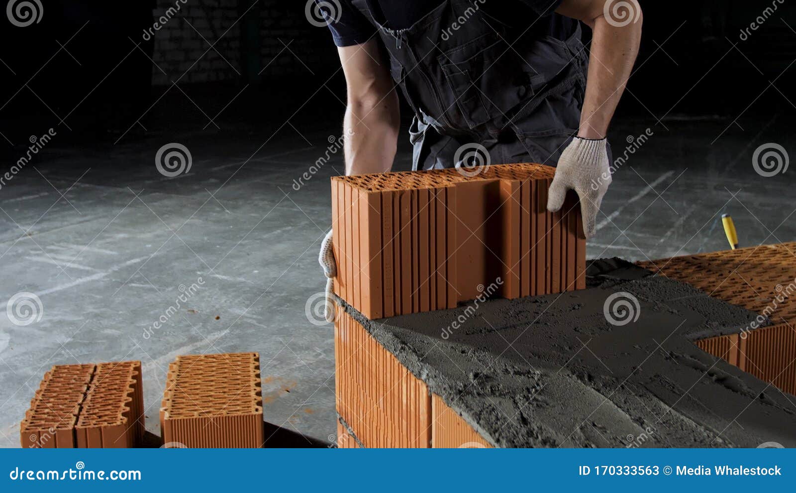Bricklayer Working at the Construction Site, Making Another Layer of a ...
