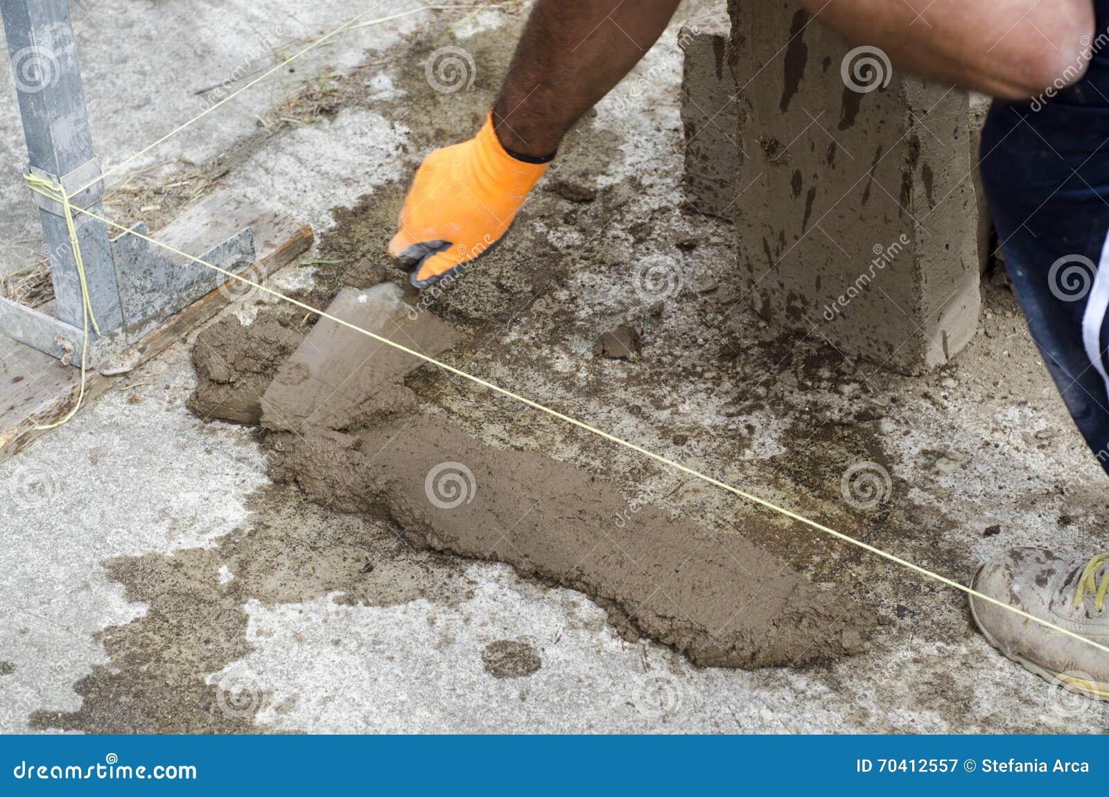 Bricklayer Working with Mud Bricks for Building a Wall. Stock Image ...