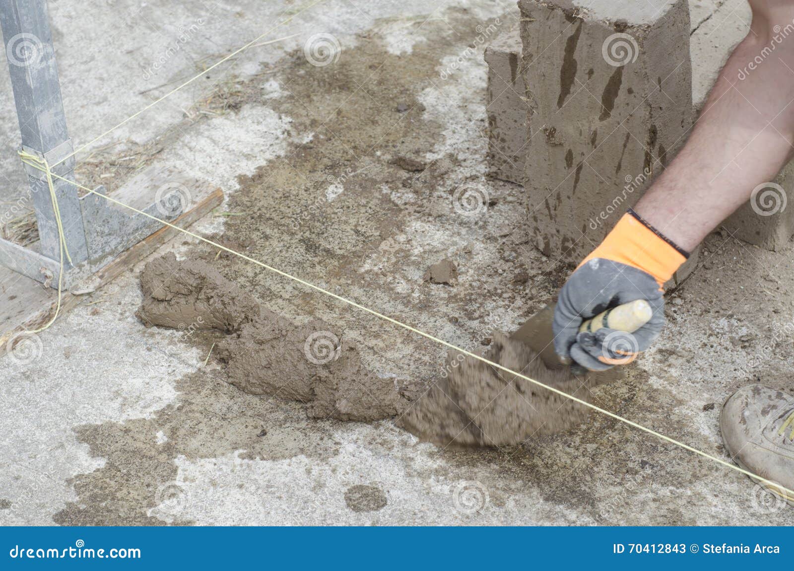 Bricklayer Working with Mud Bricks for Building a Wall. Stock Image ...