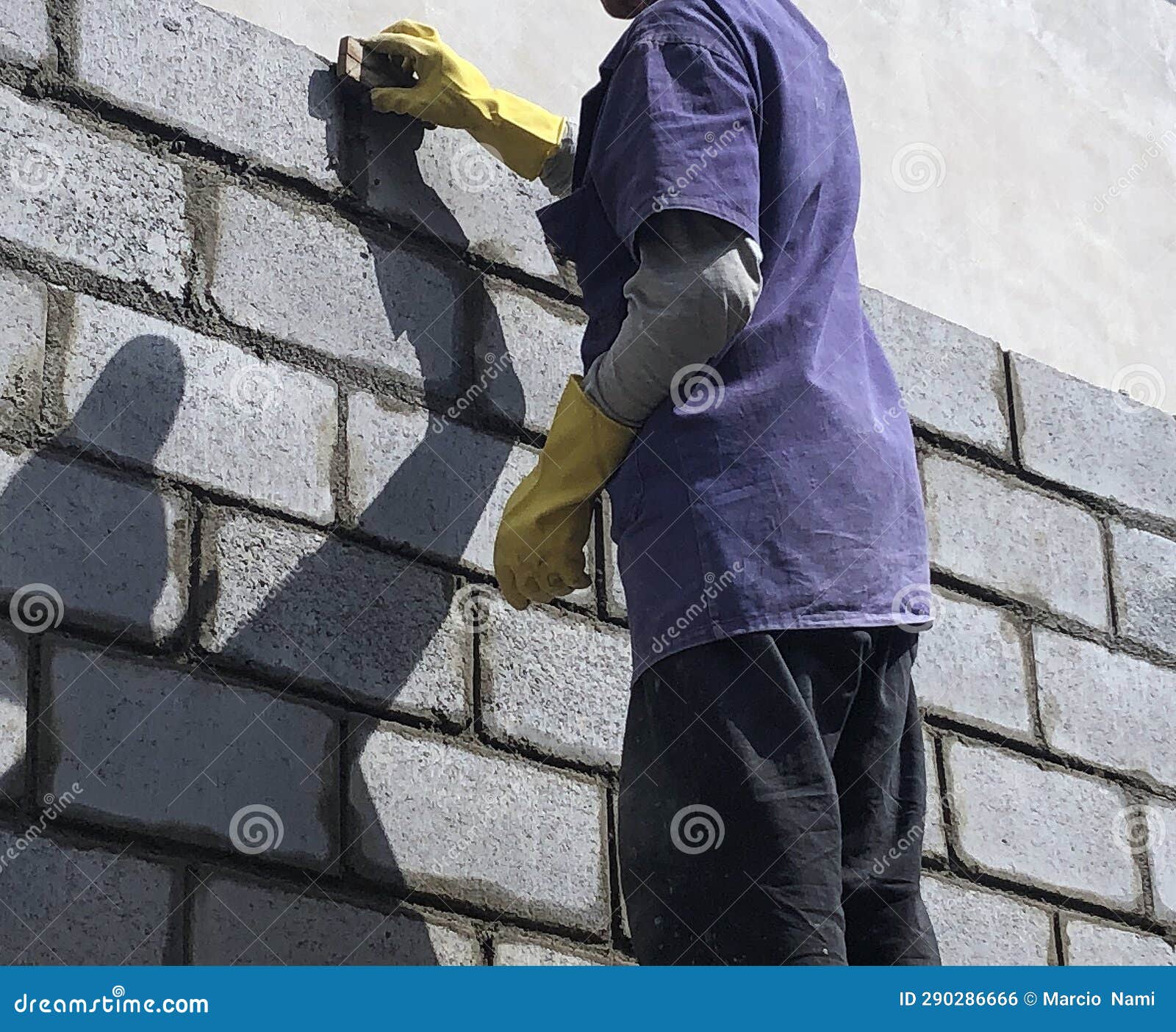 Bricklayers on Construction Scaffolding Passing Wire between Exposed ...