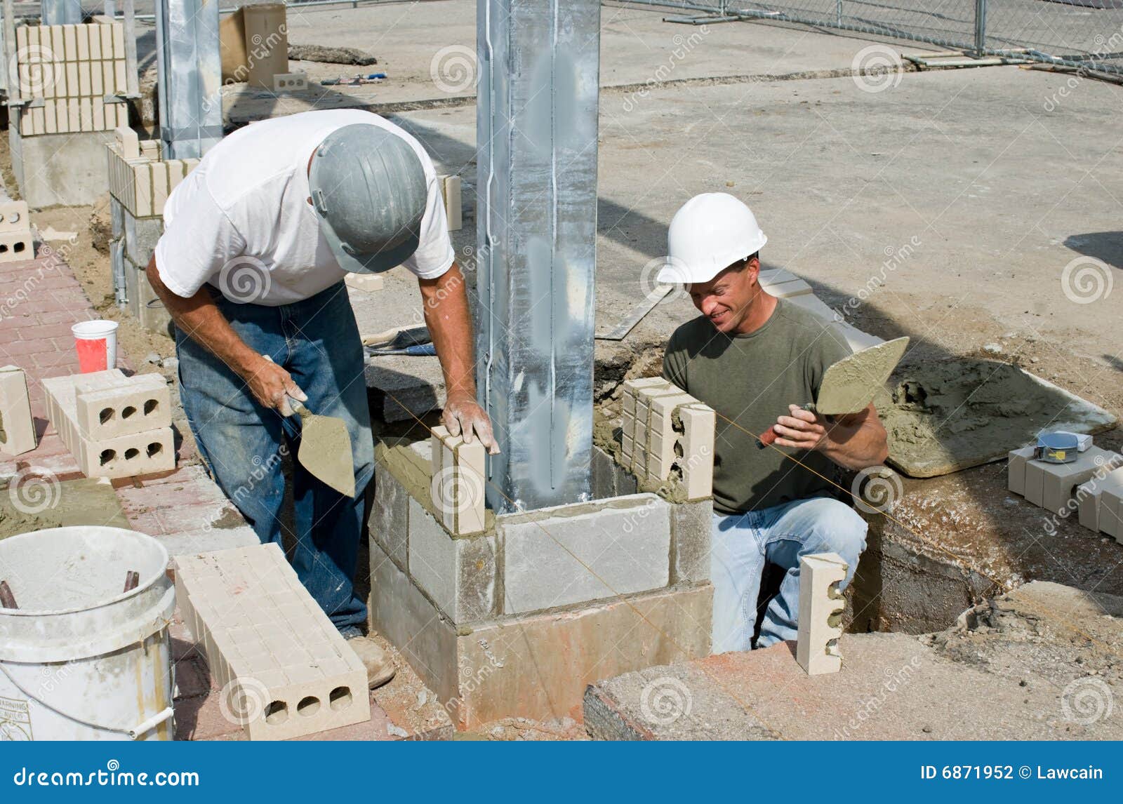 Bricklayers Installing Soldiers Stock Photo - Image of middle, build ...