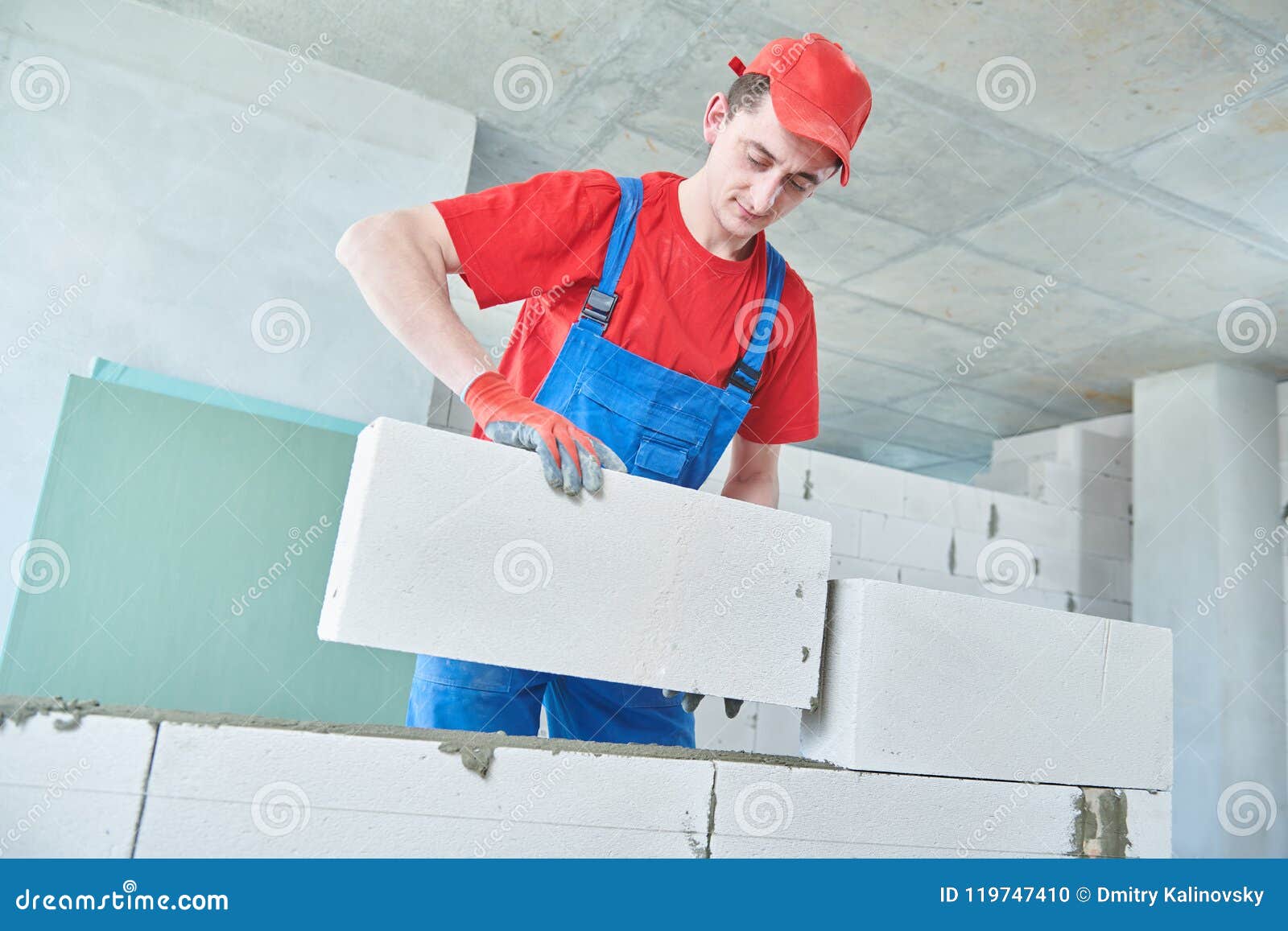 Walling. Bricklayer Installing Autoclaved Aerated Concrete Blocks ...