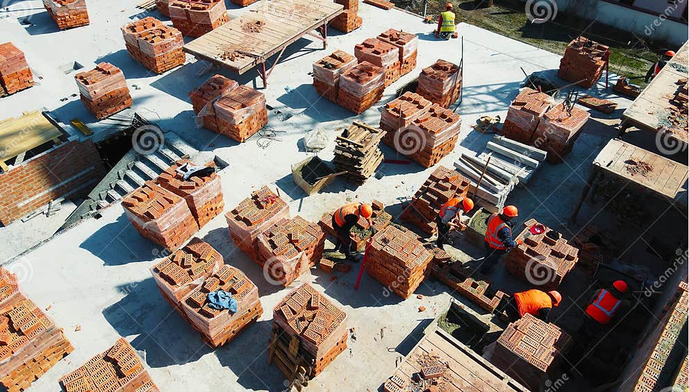 Bricklaying and Construction Workers at a Construction Site. an Aerial ...