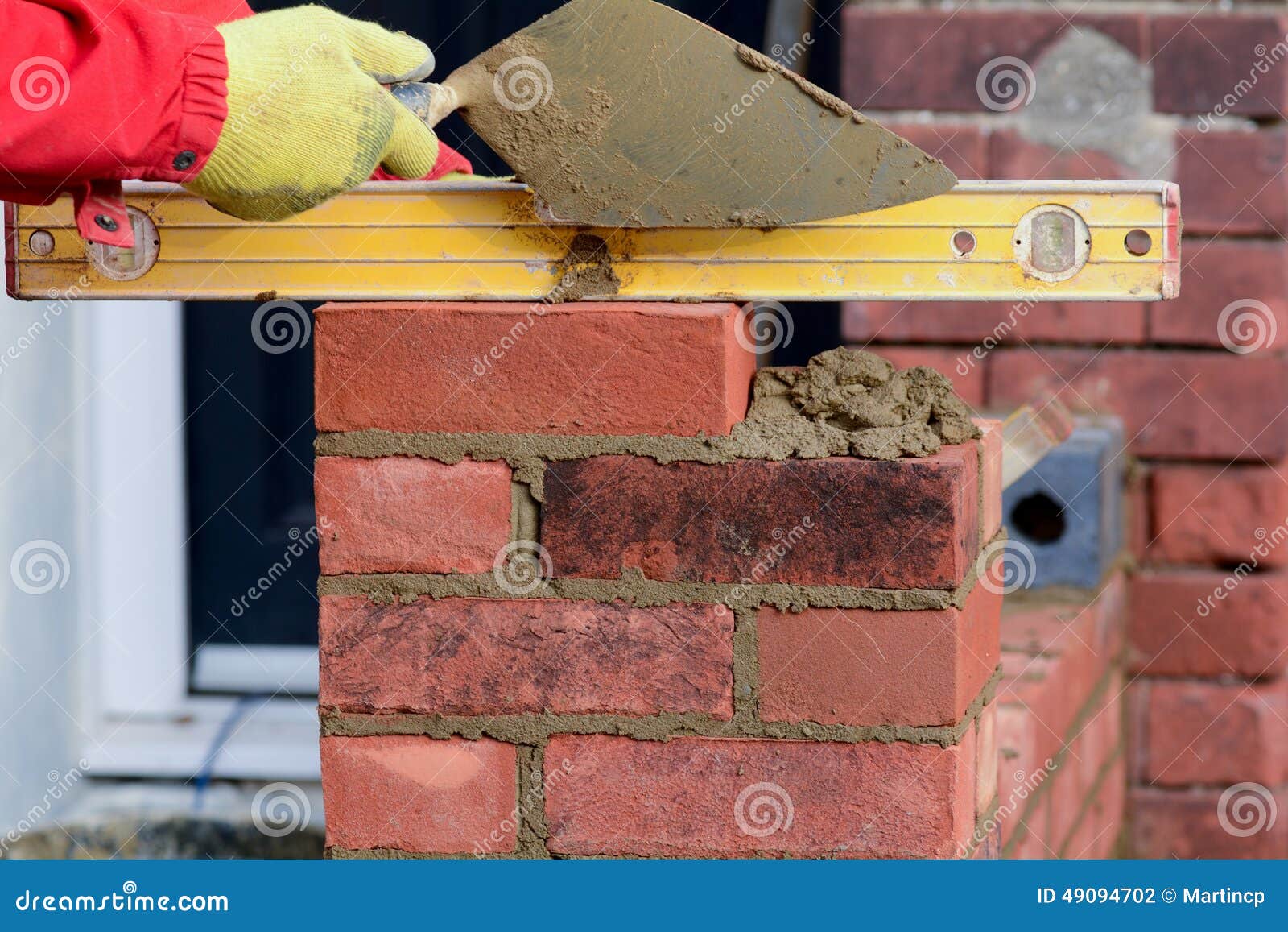 Bricklaying - Laying a Brick and Checking it is Level Stock Photo ...