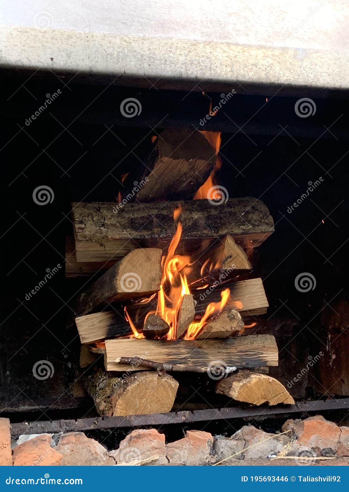 Bricks Campfire with Burning Firewood Stock Photo - Image of light ...