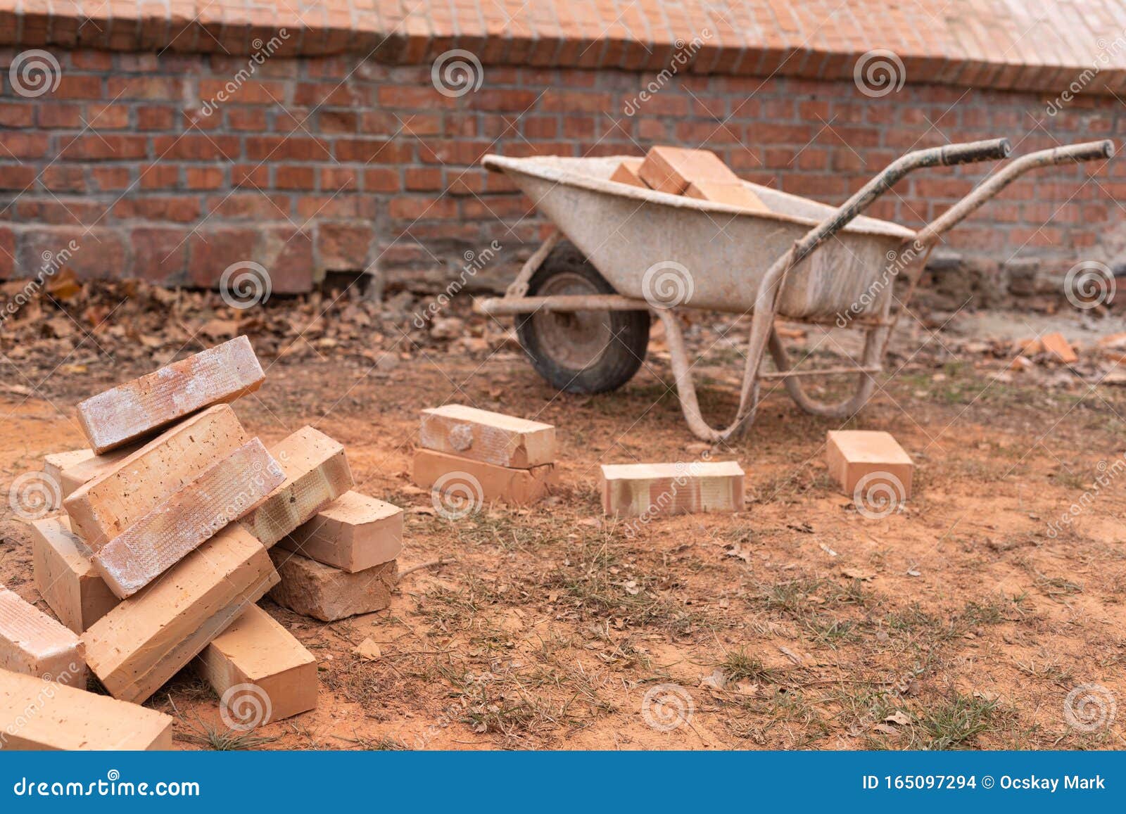 Bricks in a wheelbarrow stock photo. Image of cubes - 165097294