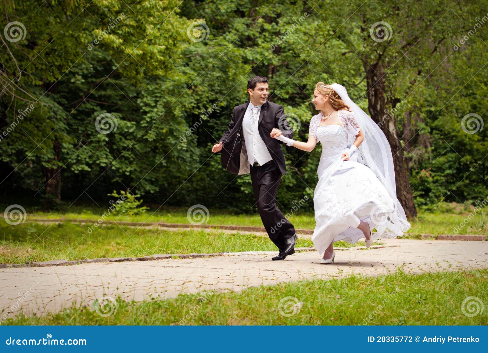Bride and Bridegroom Running Along Alley in Park Stock Photo - Image of ...