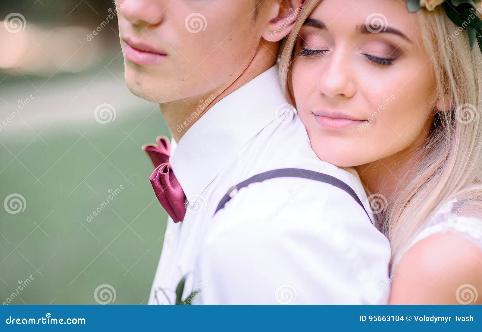 Bride Daydreams on Groom`s Shoulder while Hugging Him from Behind Stock ...