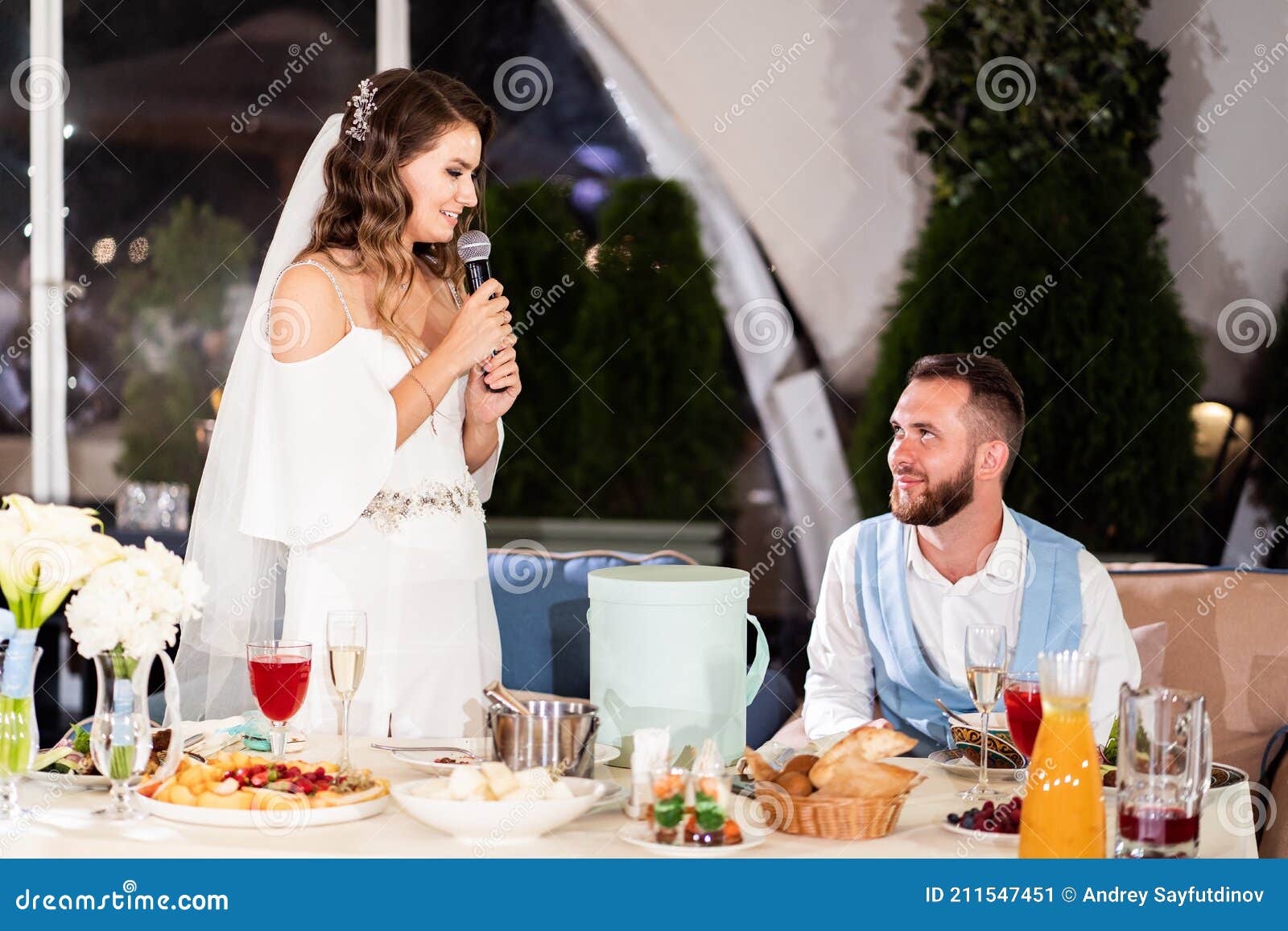 The Bride Gives a Speech into the Microphone and Congratulates the ...