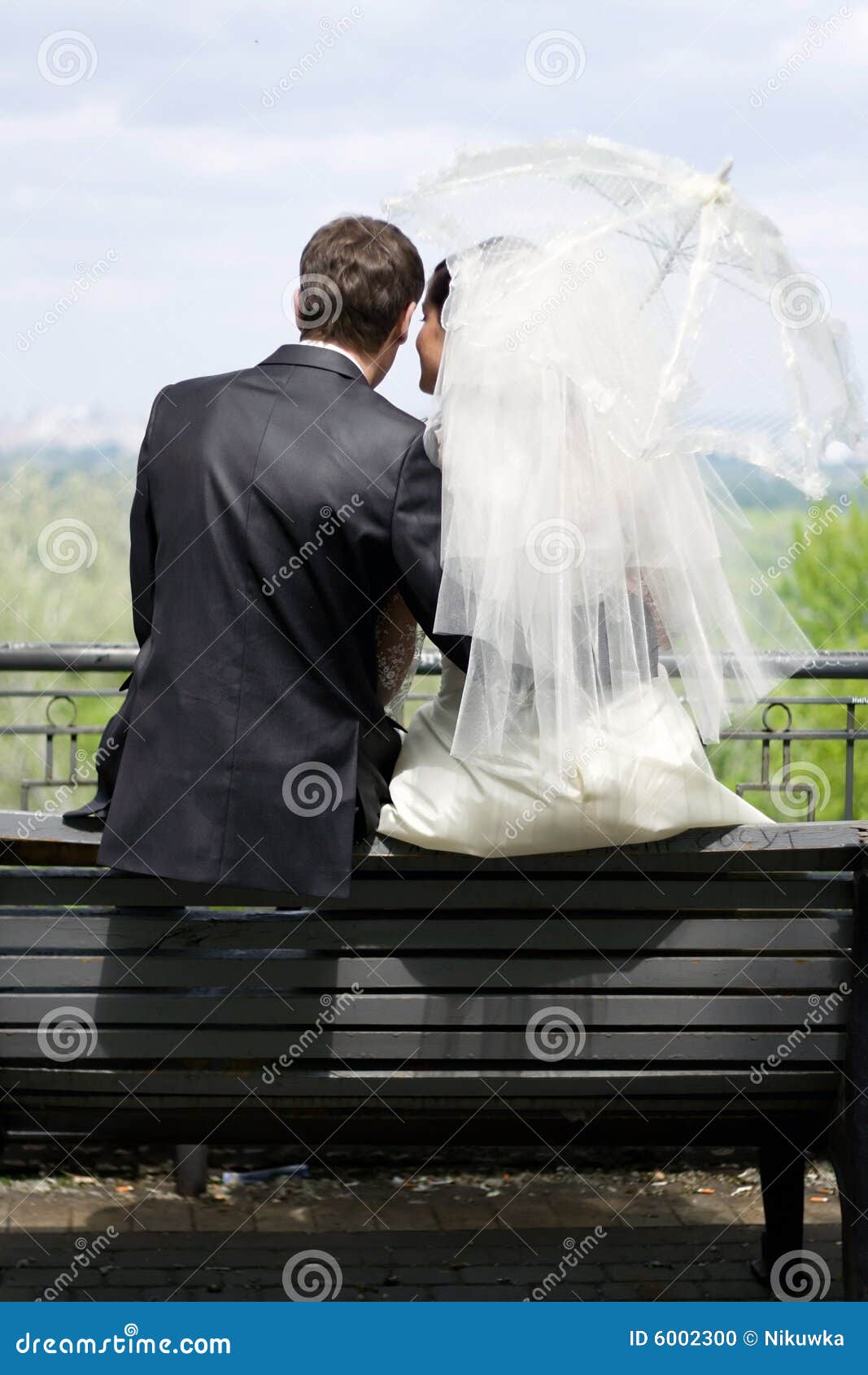 Bride and Groom on the Bench Stock Photo - Image of sitting, outside ...