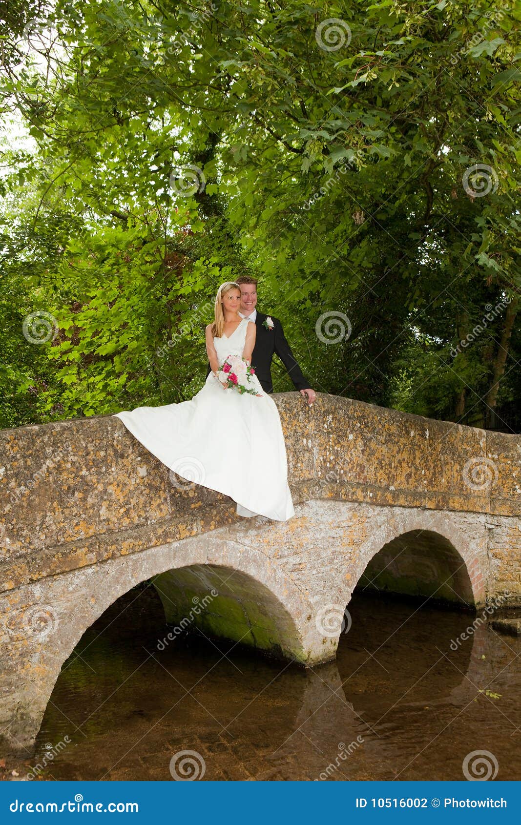 Bride and Groom on a Bridge Stock Photo - Image of bridegroom, smiling ...